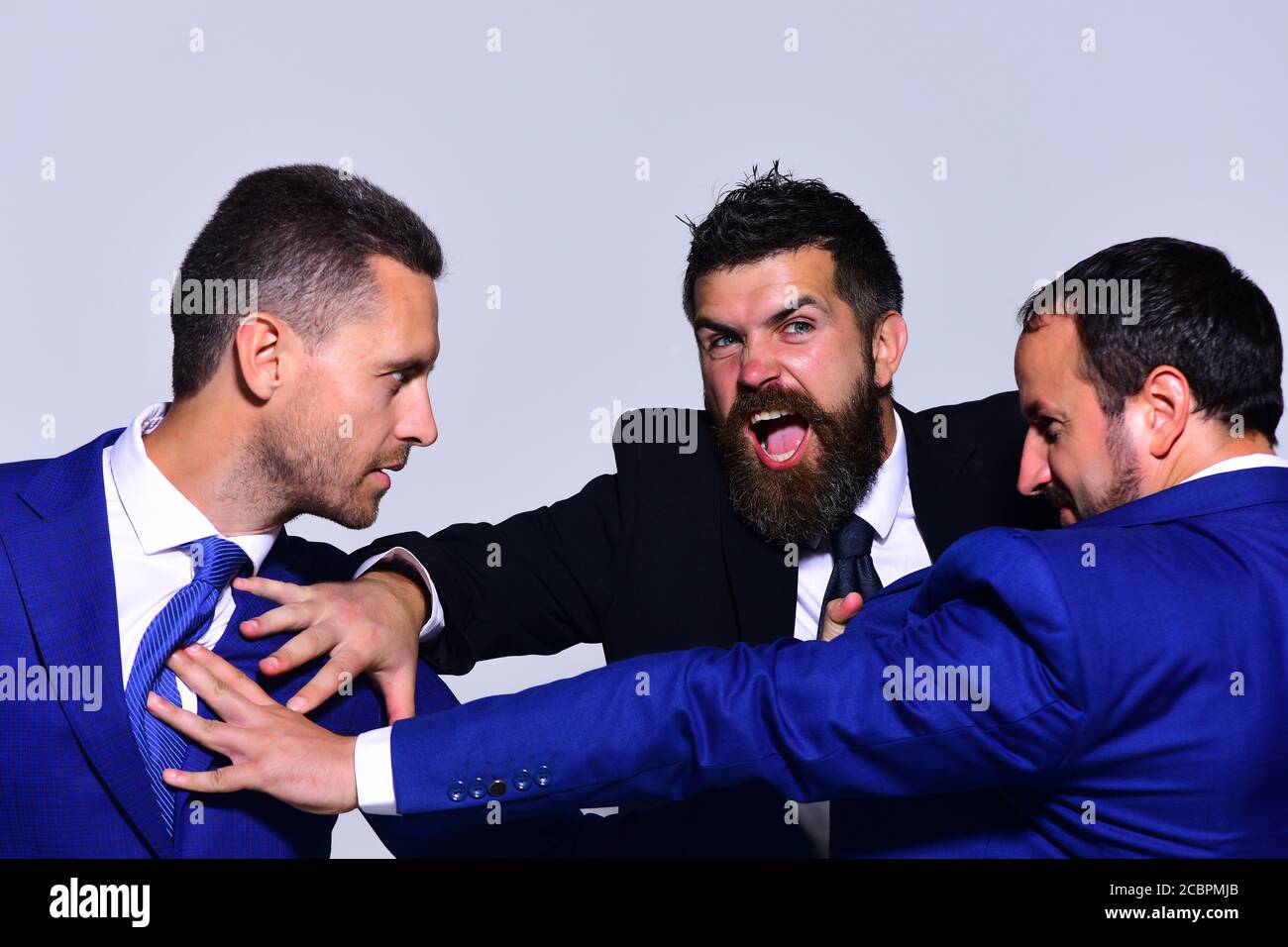 Rivalry and business confrontation concept. Businessmen with strict and ...