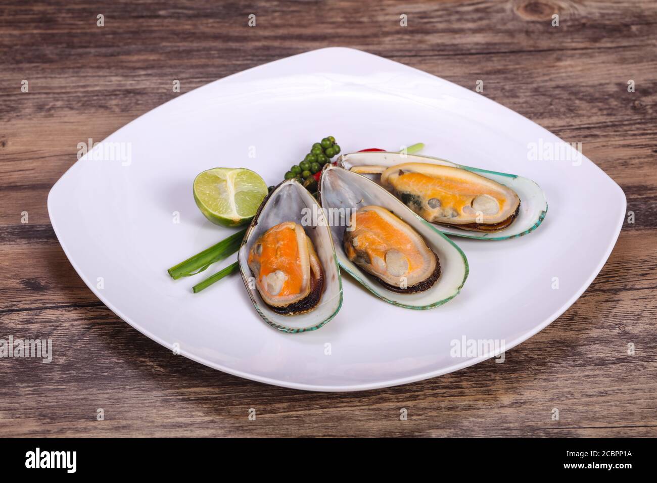 Half mussels with lime and green pepper Stock Photo - Alamy