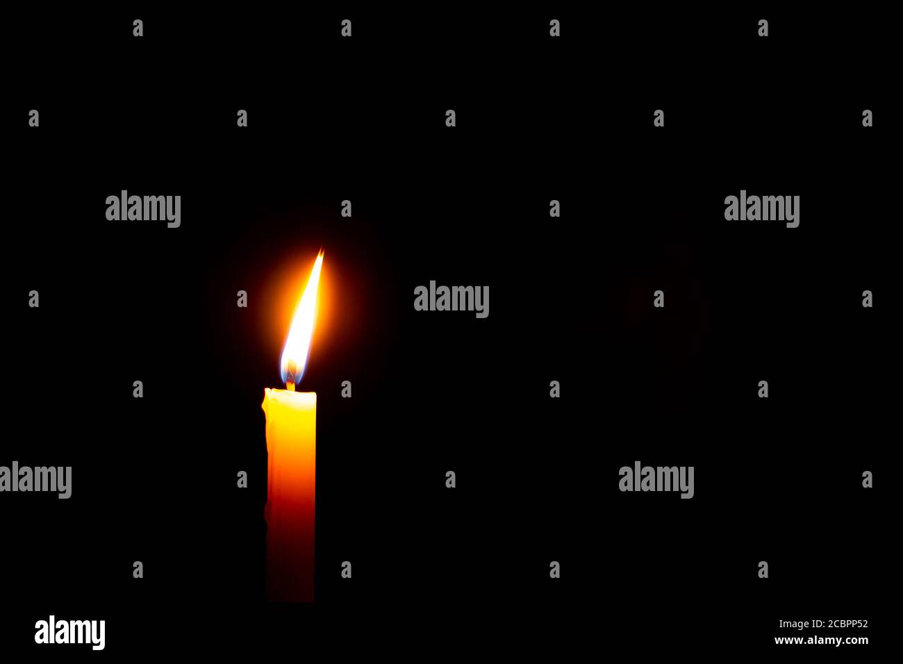 Beautiful lone candle burning against dark background Stock Photo - Alamy