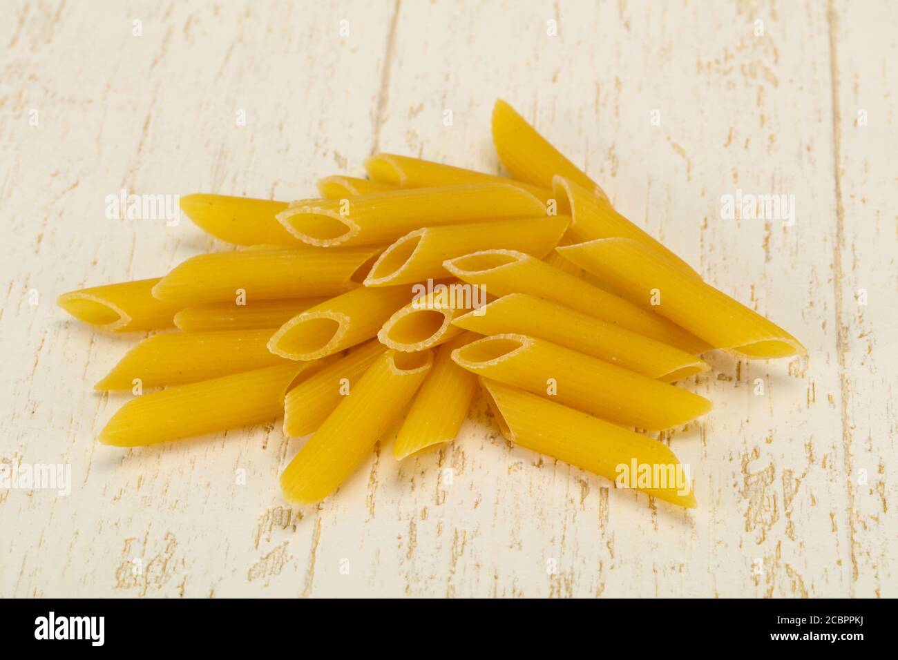 Raw penne pasta ready for bowl Stock Photo - Alamy