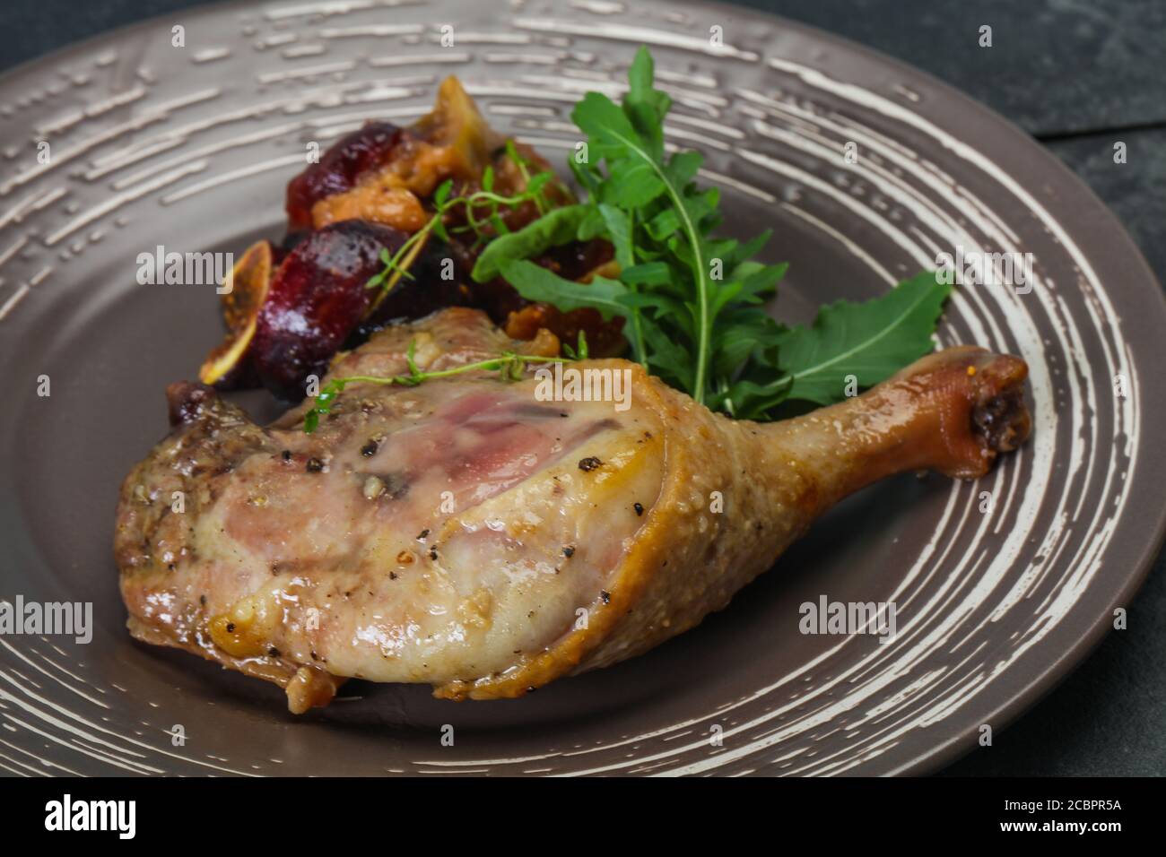 Roasted. duck. leg with plum, fig and apple Stock Photo - Alamy