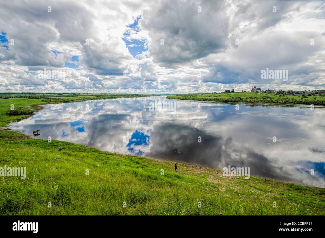 Summer on the Onega River. Reflection of clouds in water Stock Photo ...