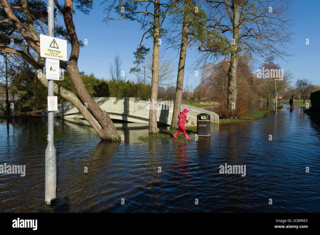 People walking along a flooded path, in North Walls Recreation Ground ...