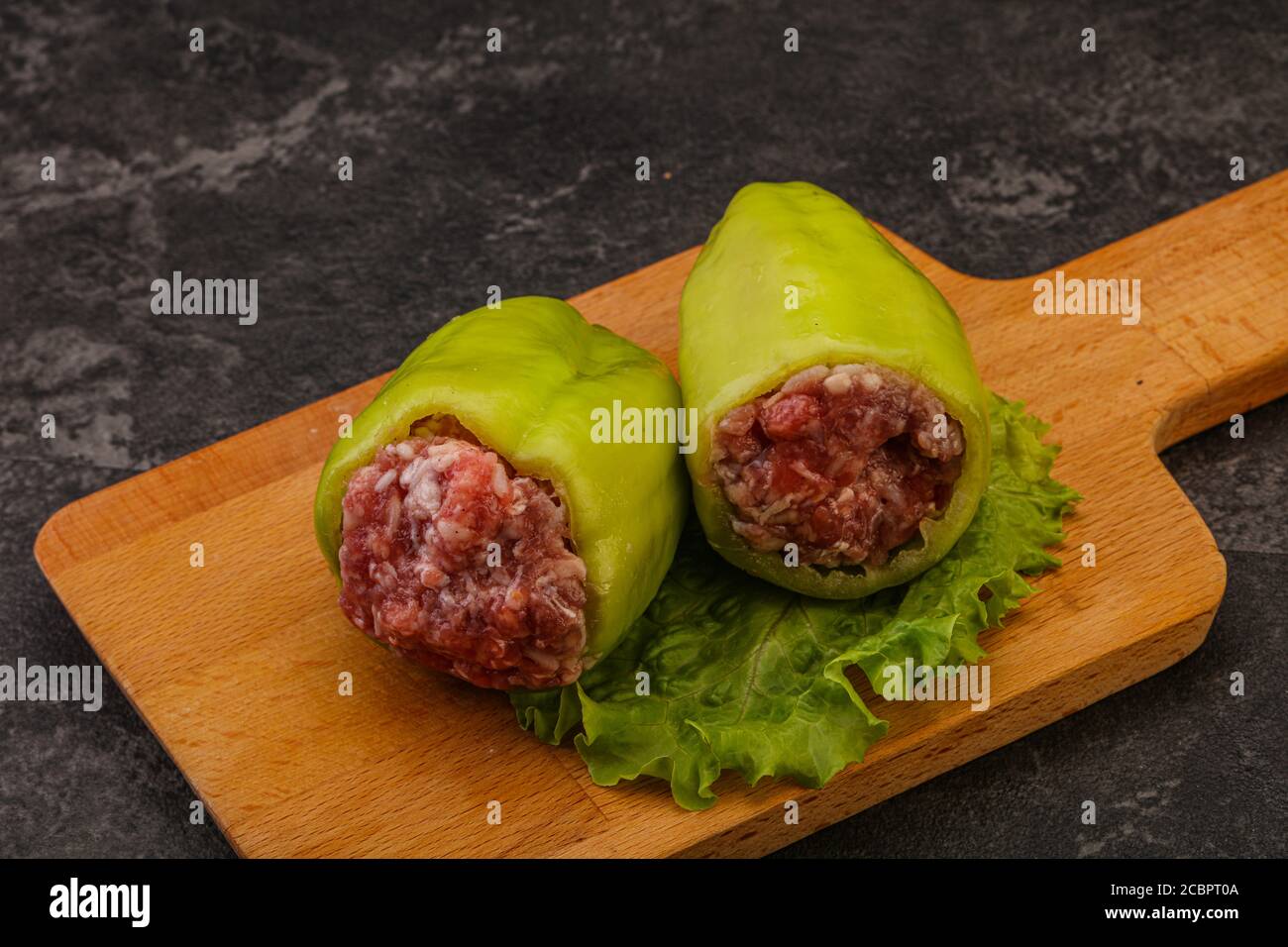 Raw stuffed green bell pepper with meat Stock Photo - Alamy