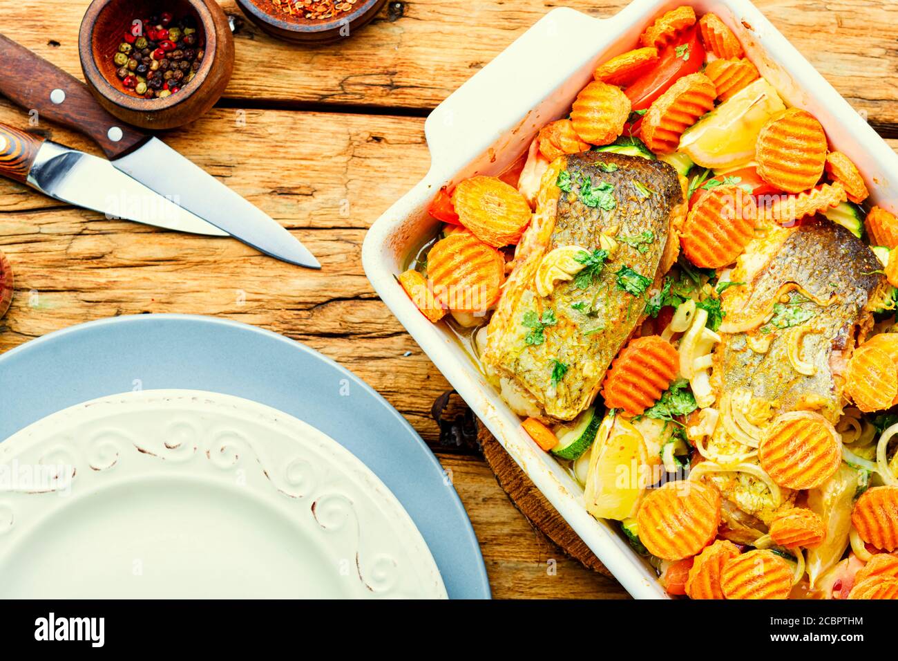Baked fish steaks with grilled vegetables in baking dish.Delicious ...