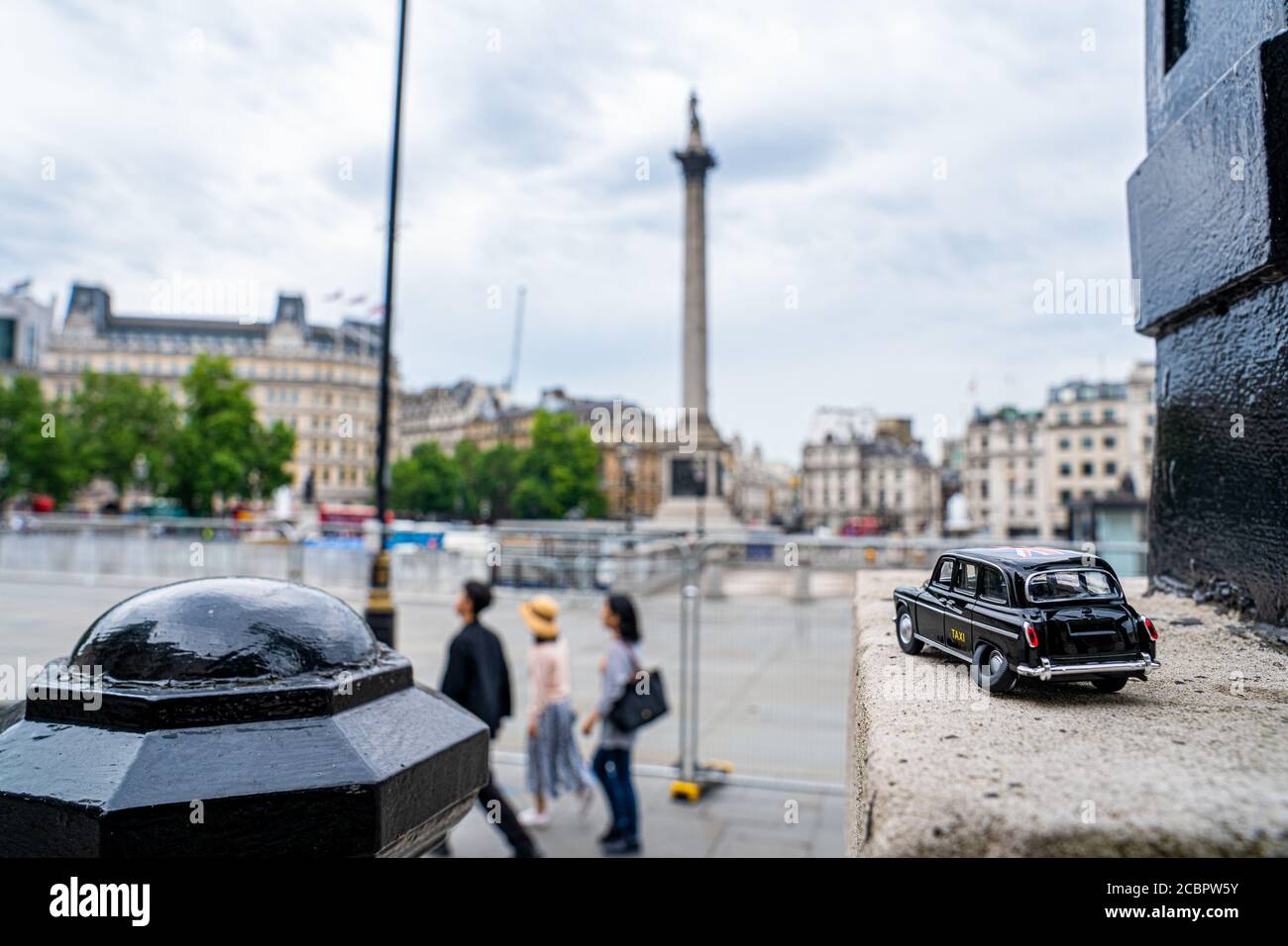 Closeup shot of a traditional black cab driving through the most famous ...