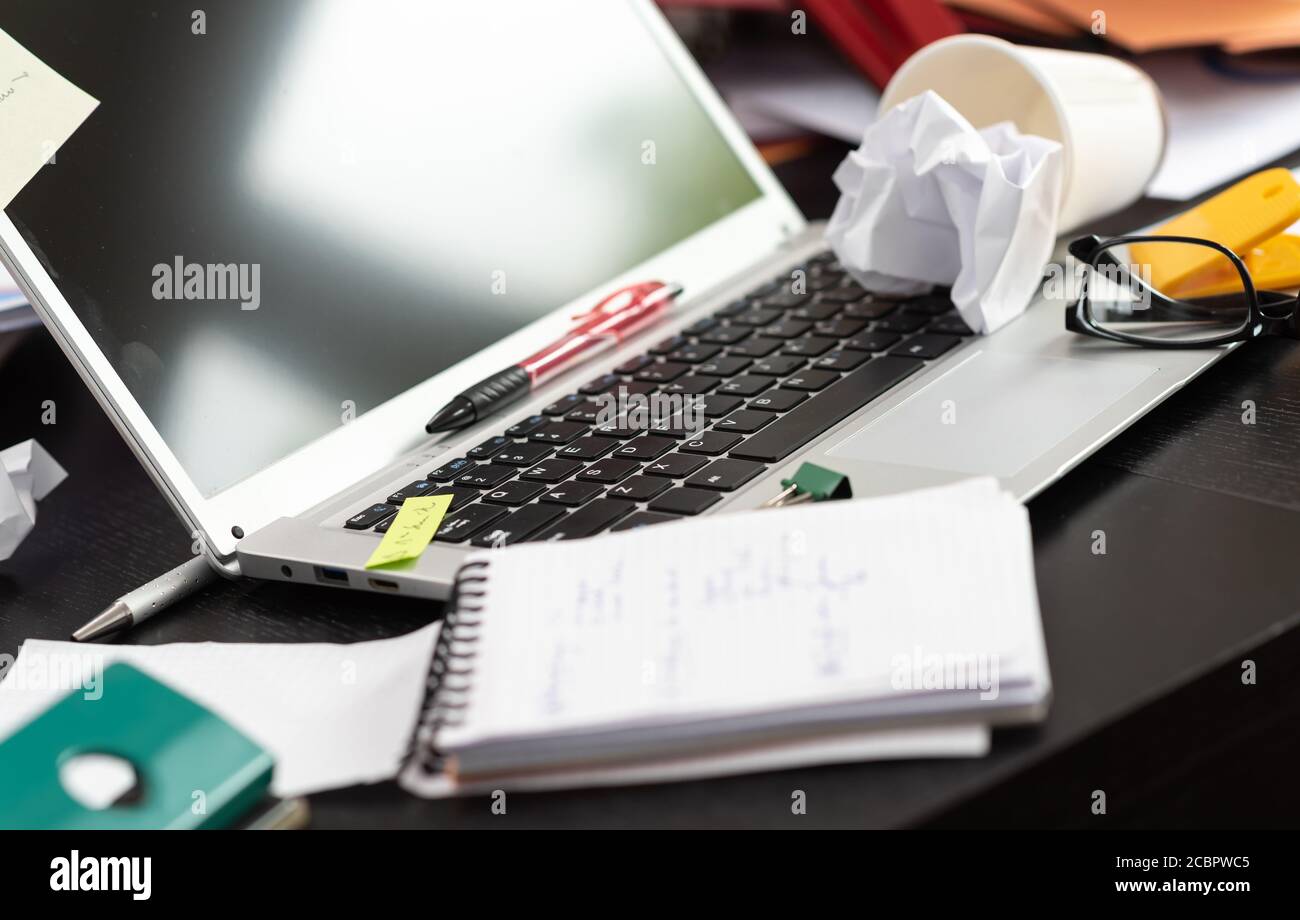 Messy and cluttered office desk Stock Photo - Alamy