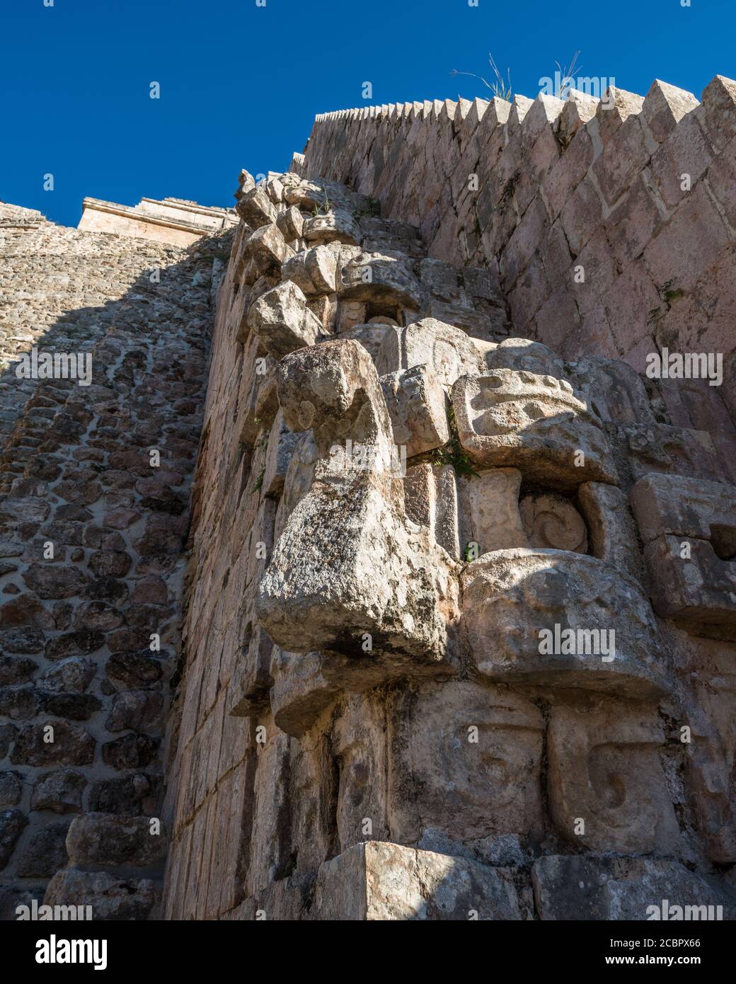 A row of Chaac masks line the stairway on the west facade of the ...