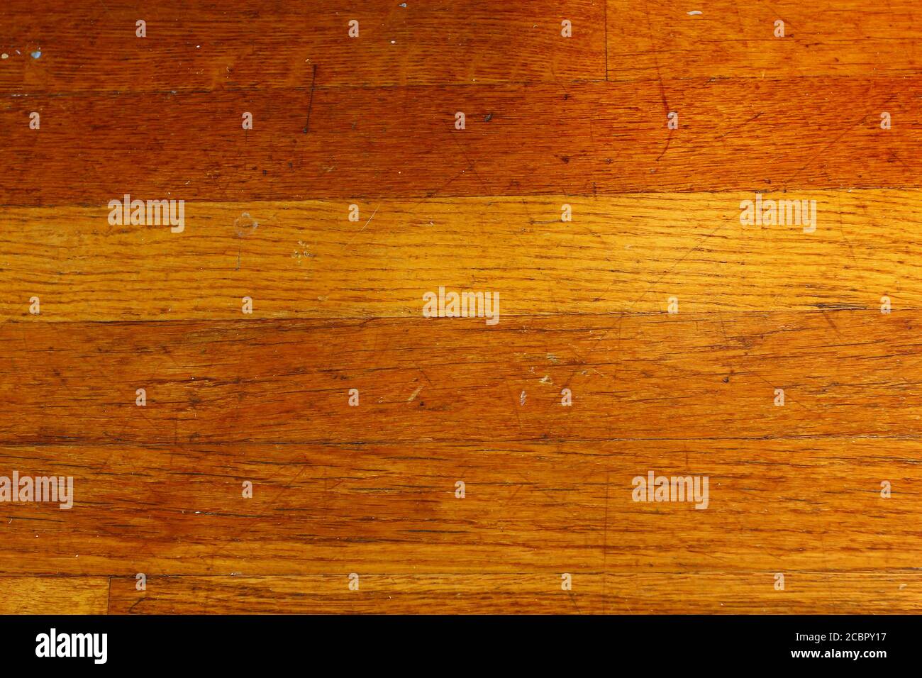 Top view of a wooden laminate flooring with scratches under the lights ...