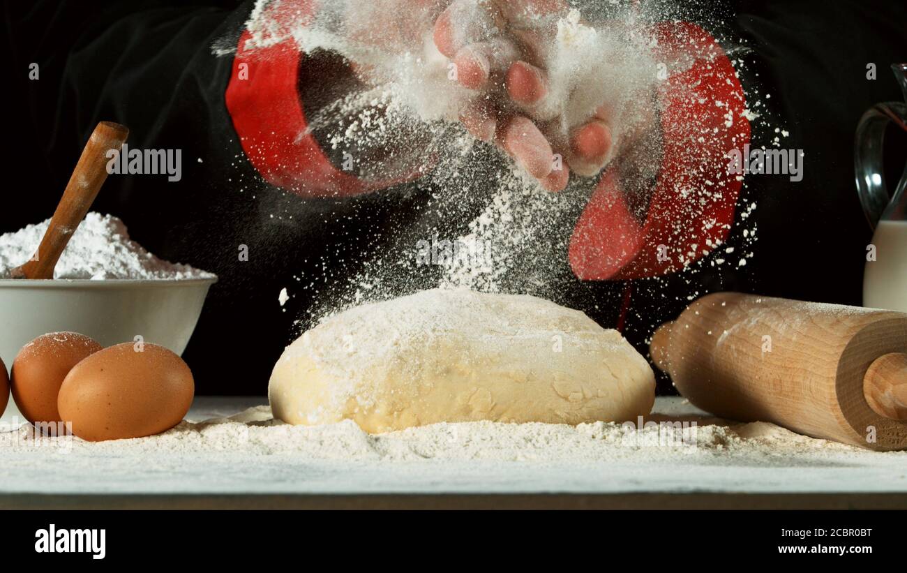Freeze motion of cooker with clapping hands above yeast dough. Food ...