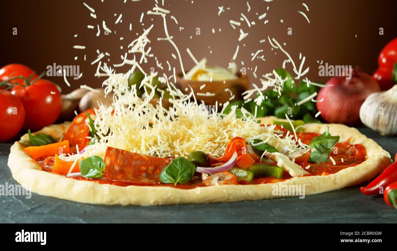Falling mozzarella cheese on pizza, freeze motion. Italian traditional ...
