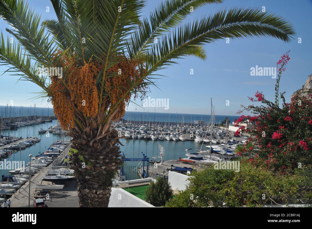 Sunny scenery of a beautiful coastal harbor with lots of boats Stock ...