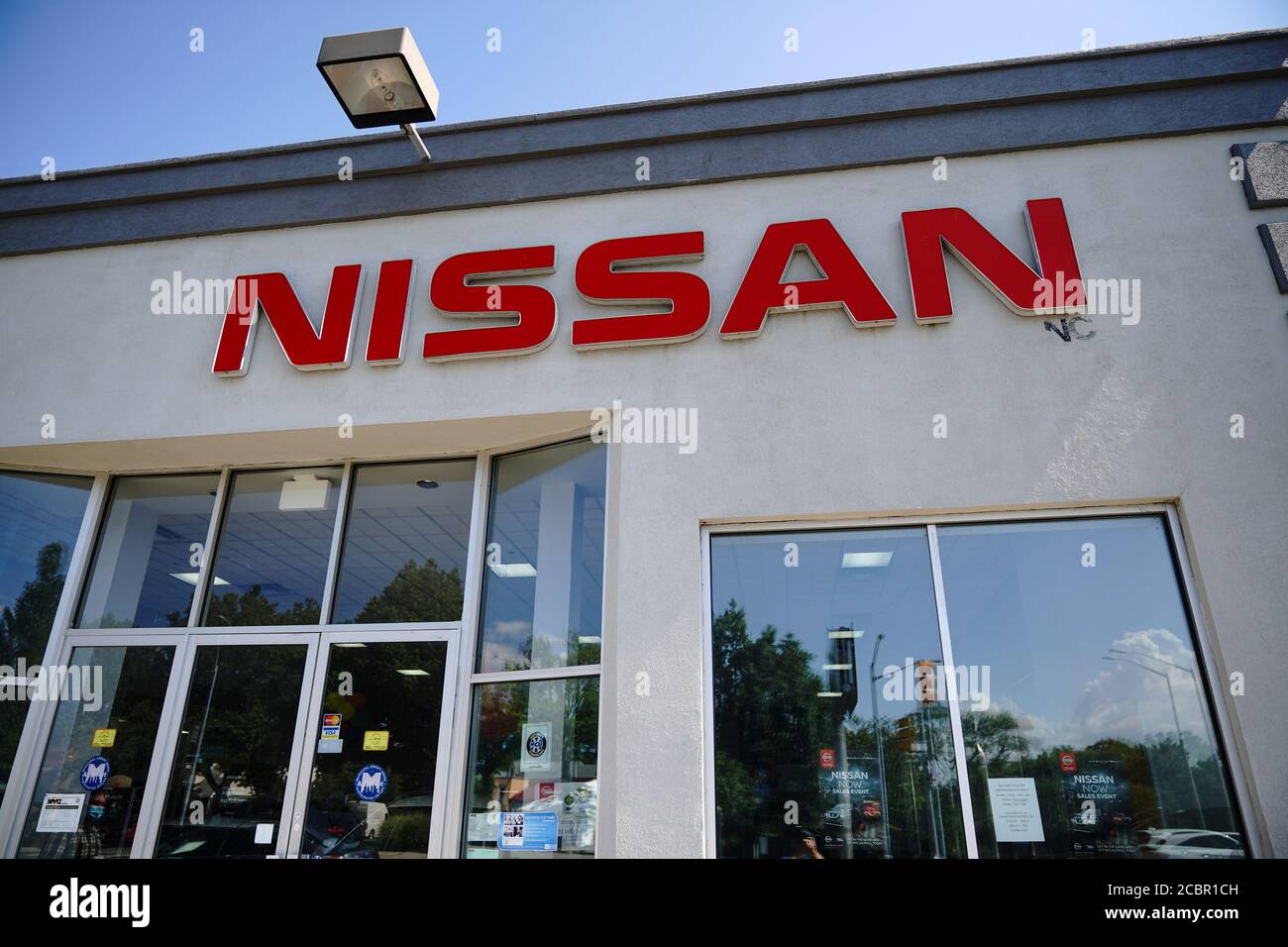 Nissan company logo seen on one of their car dealerships showrooms ...