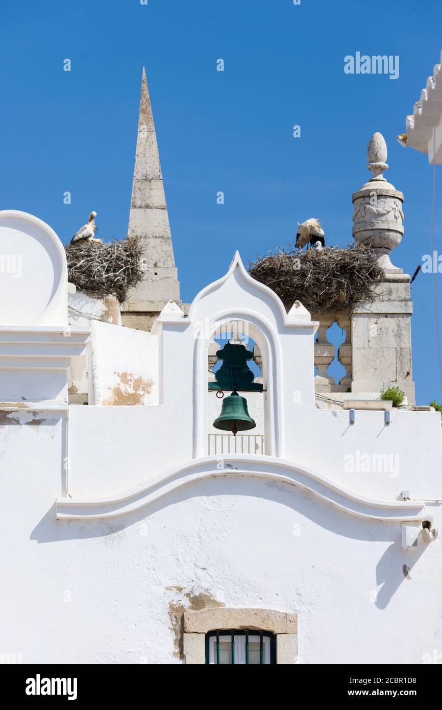 stork nests on Arco da Vila, a medieval gate in Faro, Algarve, Portugal ...