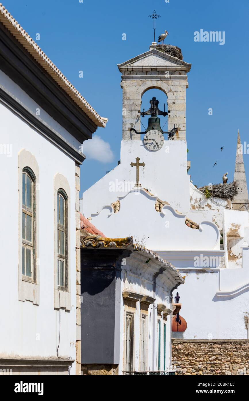 stork nests on Arco da Vila, a medieval gate in Faro, Algarve, Portugal ...