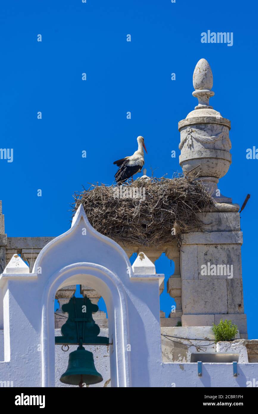stork nests on Arco da Vila, a medieval gate in Faro, Algarve, Portugal ...