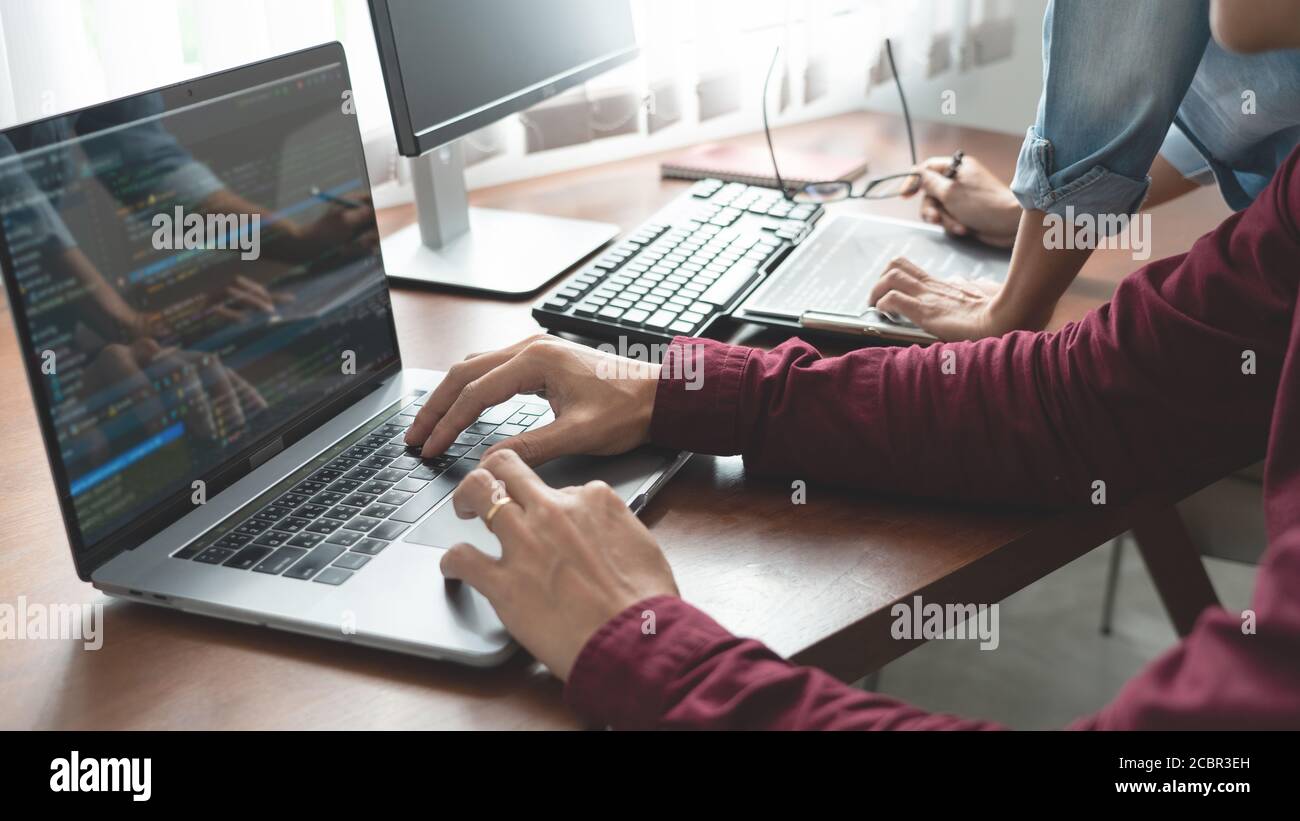 Team of Programmer working to find solution to problem and coding ...