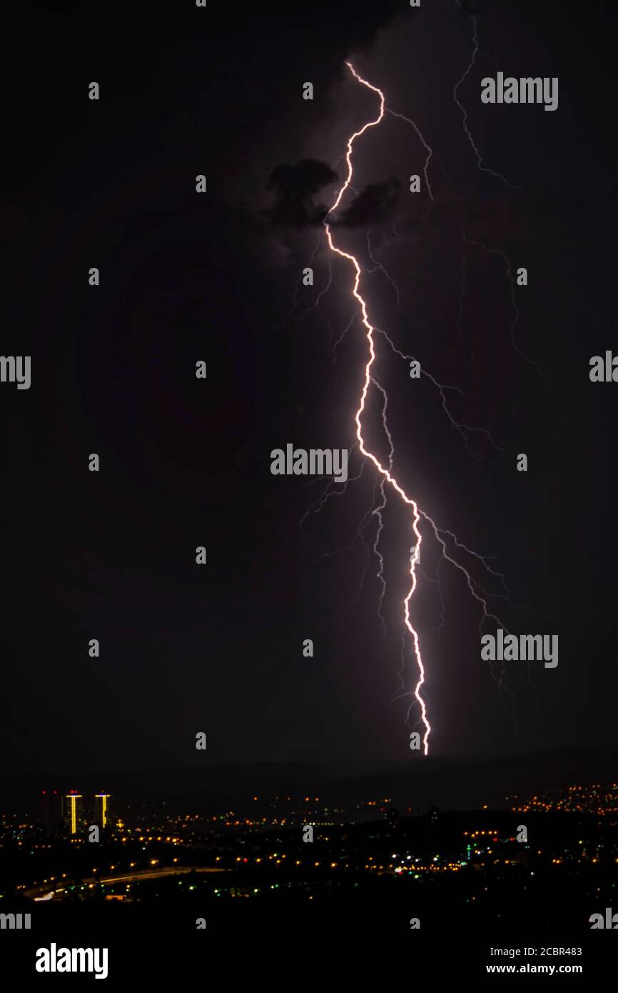 Vertical shot of lightning above a city at night - great for wallpapers ...