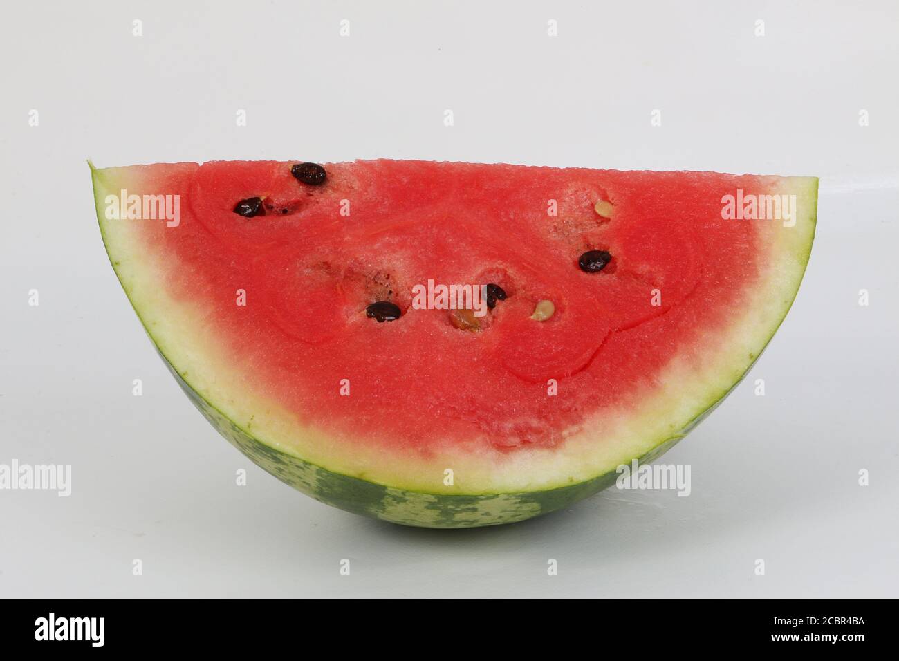 Slice of a watermelon isolated on a white background Stock Photo - Alamy