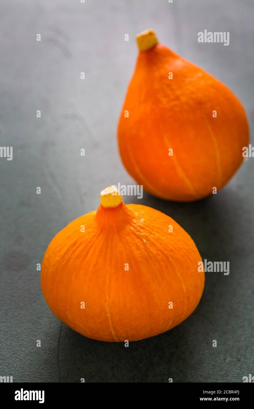 Red kuri squash on green background. Delicious edible pumpkins Stock ...