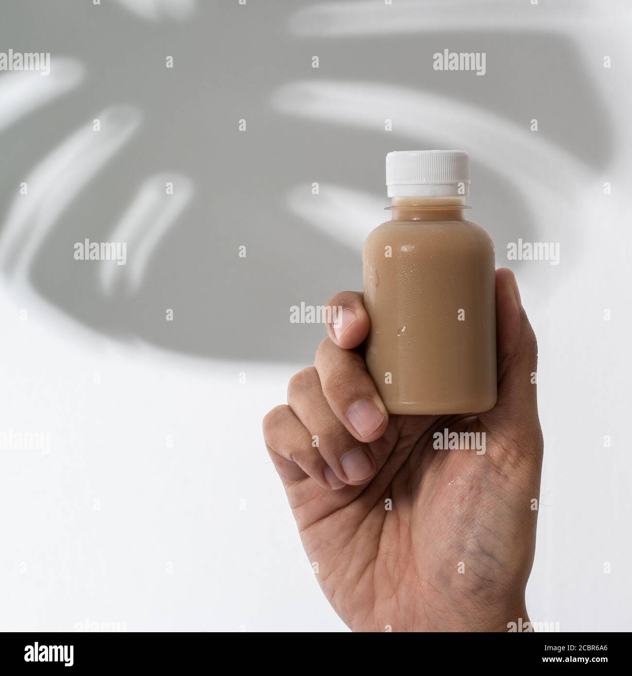 gesture of hand holding plastic bottle product mockup Stock Photo - Alamy