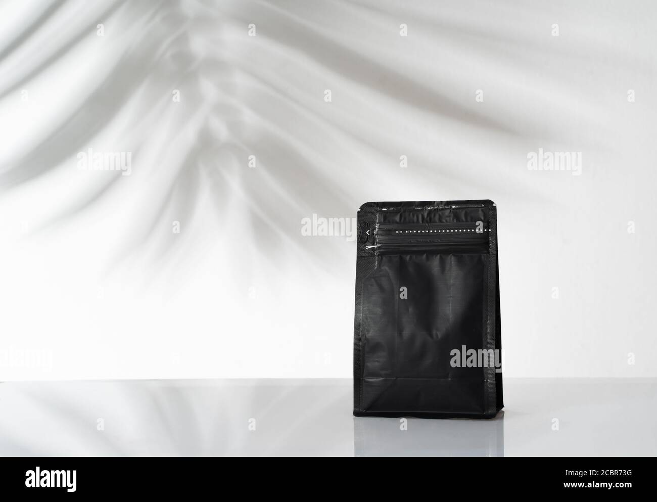 blank black standing pouch container over white background. product ...