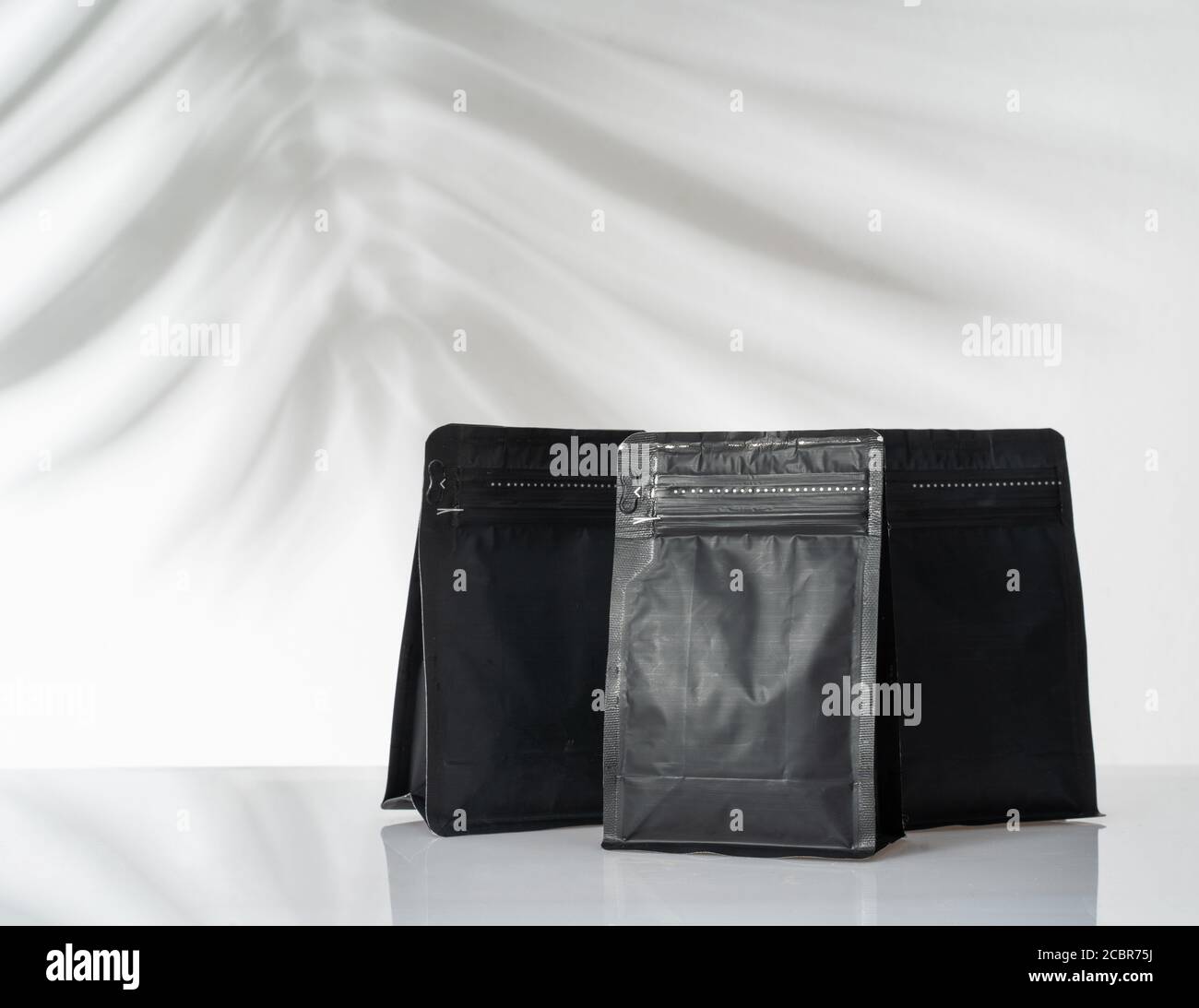 blank black standing pouch container over white background. product ...