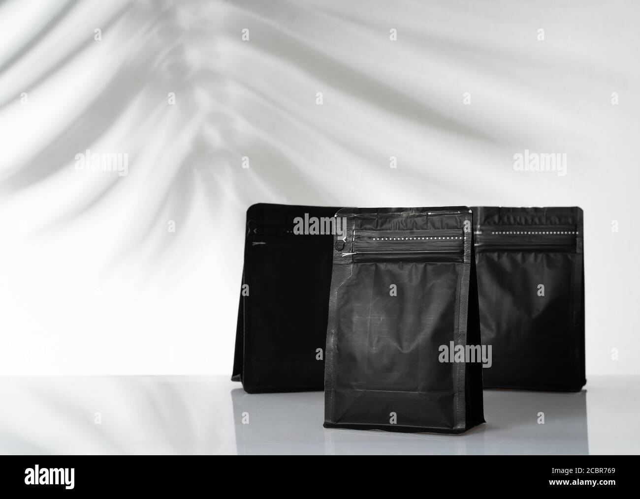 blank black standing pouch container over white background. product ...