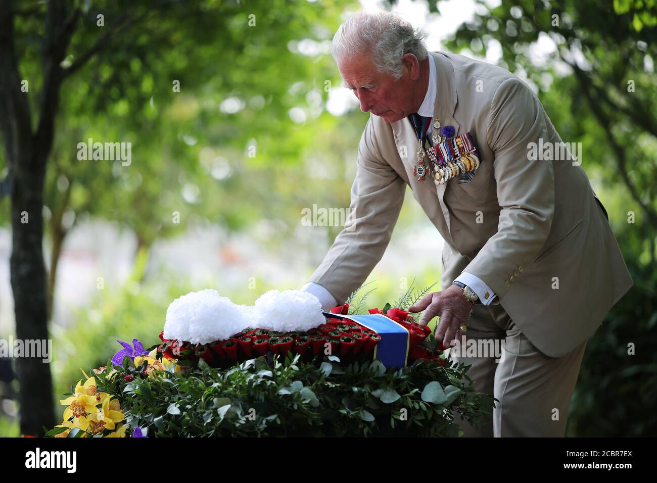 The Prince of Wales lays a wreath during the national service of ...