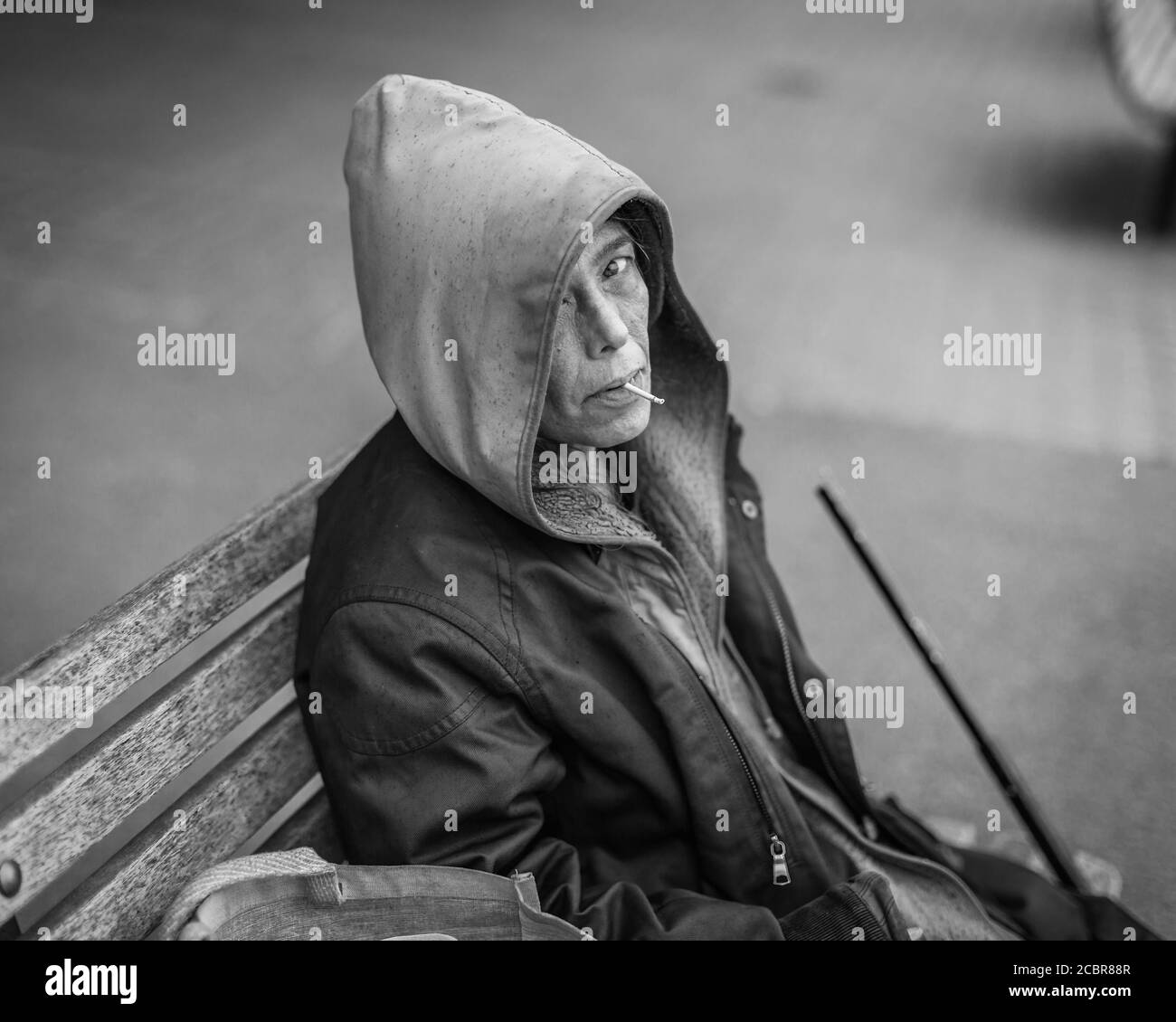 Portrait of a homeless person on a bench on the riverside on the south ...