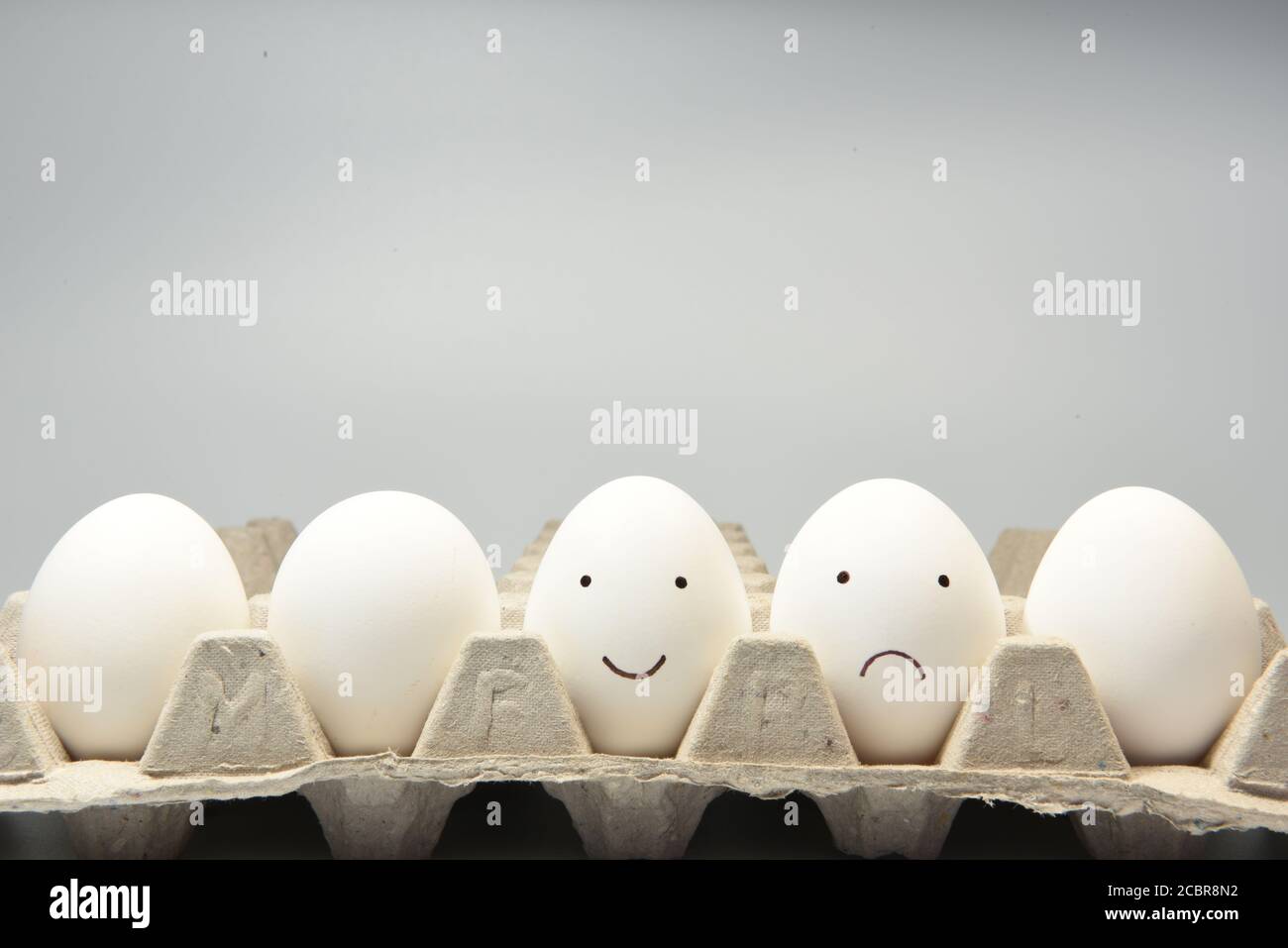 Happy face smiley and sad face smiley on egg shells Stock Photo - Alamy