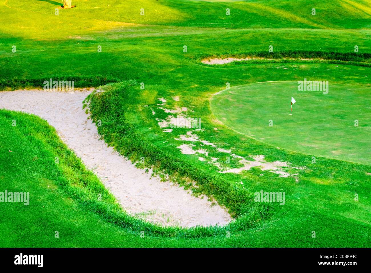 An empty golf course green a little run down Stock Photo - Alamy