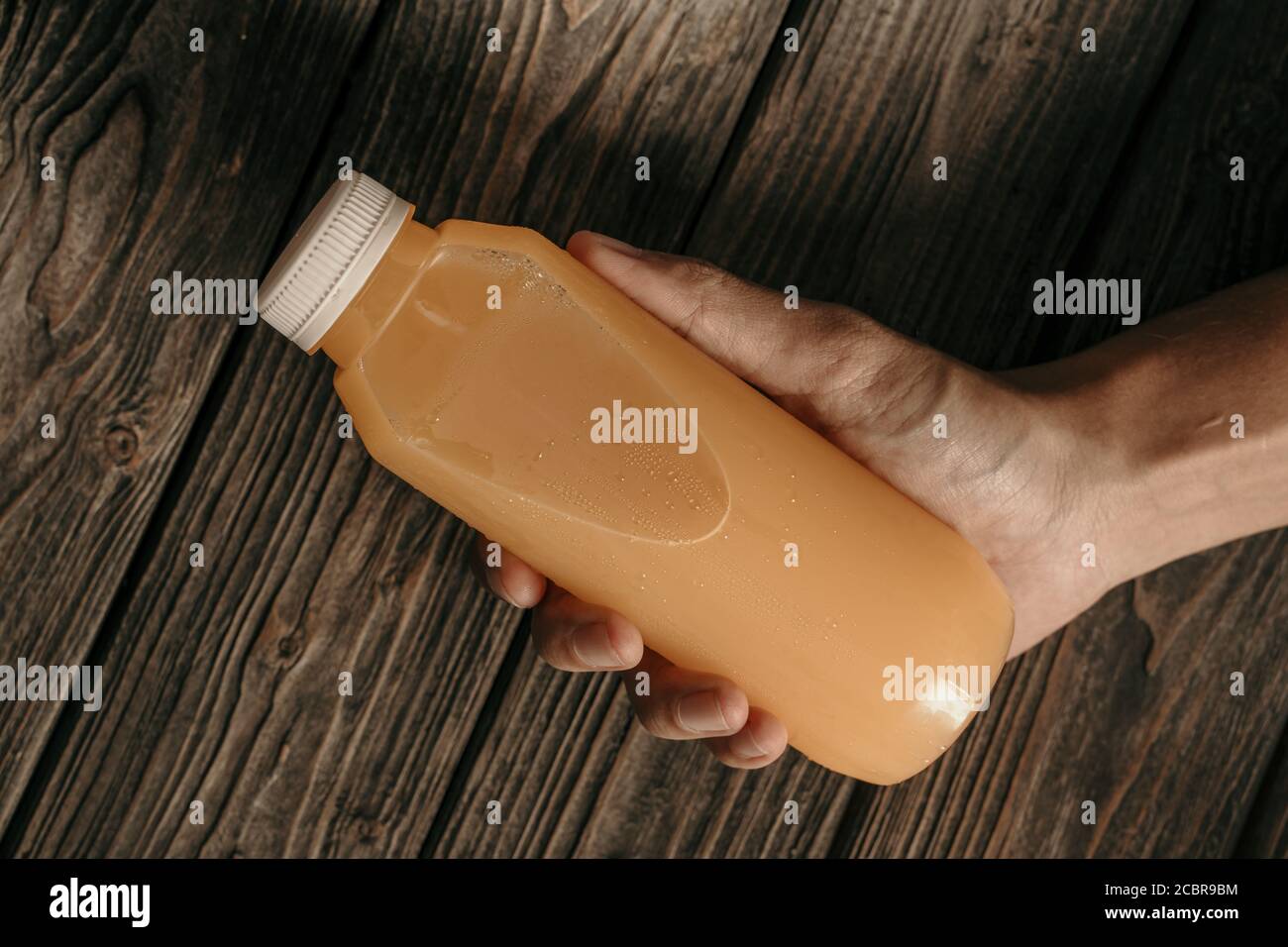 gesture of hand holding plastic bottle product mockup Stock Photo - Alamy