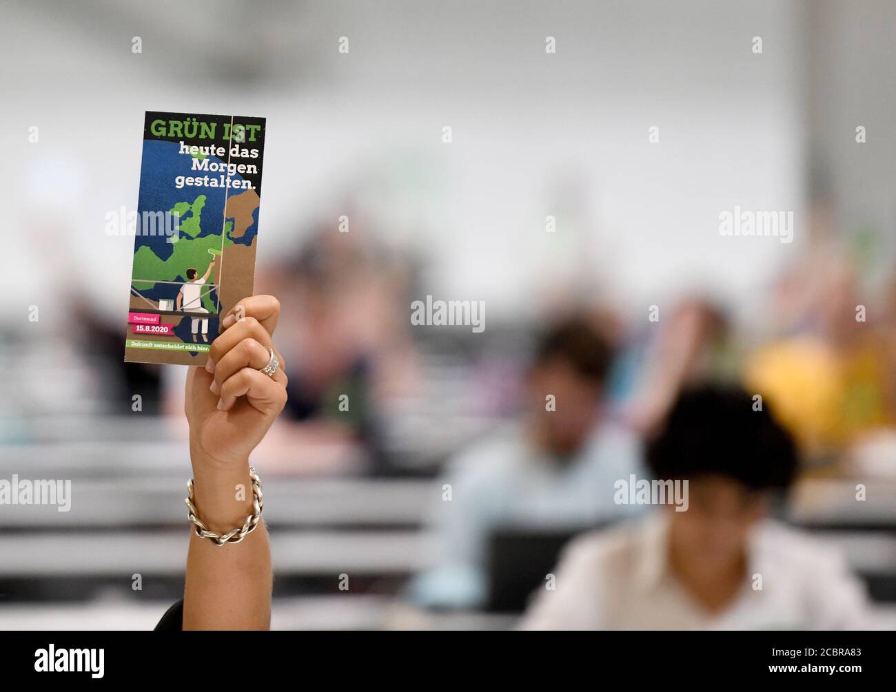 Dortmund, Germany. 15th Aug, 2020. A delegate holds up her voting card ...