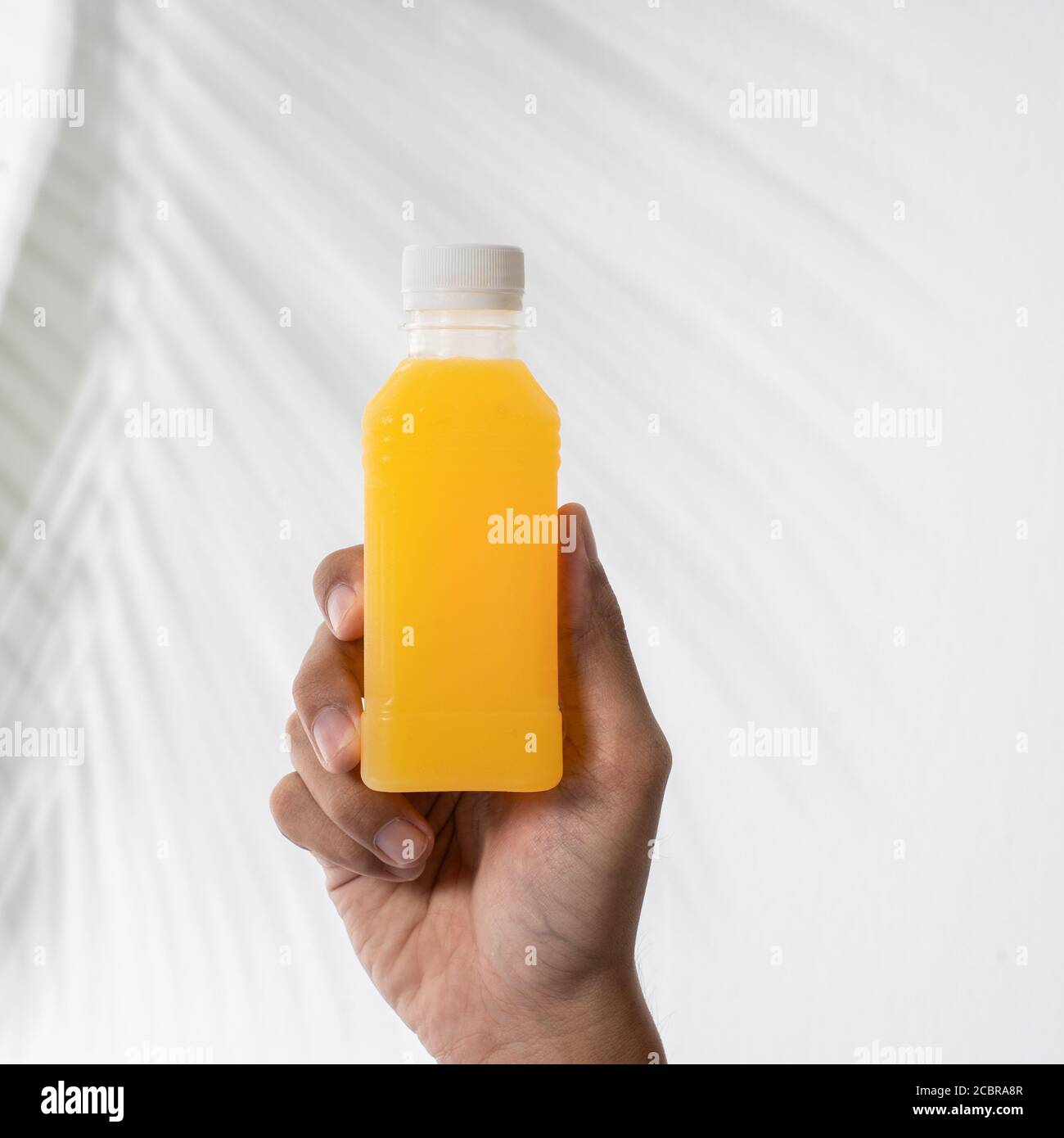 gesture of hand holding plastic bottle product mockup Stock Photo - Alamy
