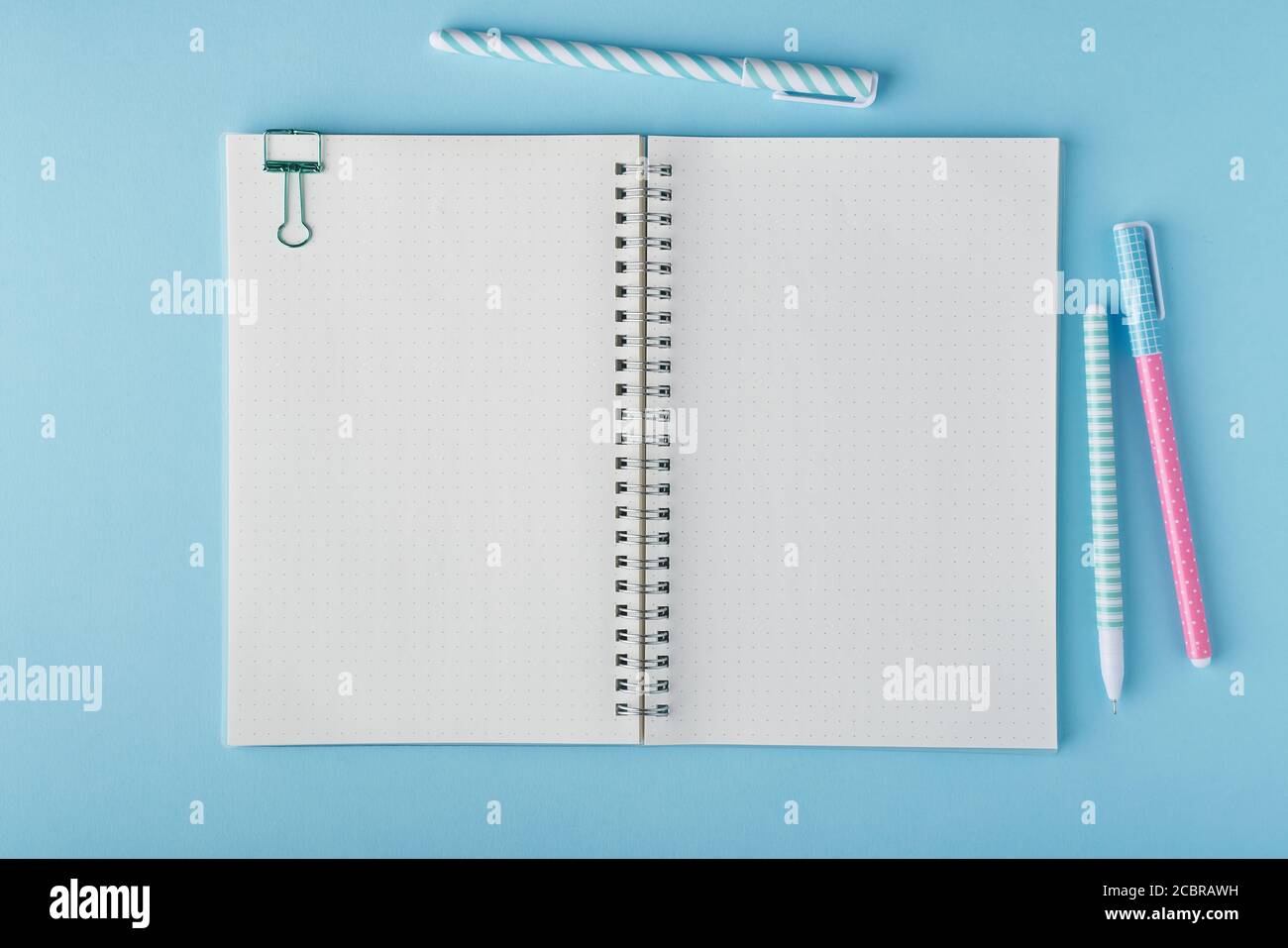 Blank notepad page in bullet journal on bright blue office desktop ...