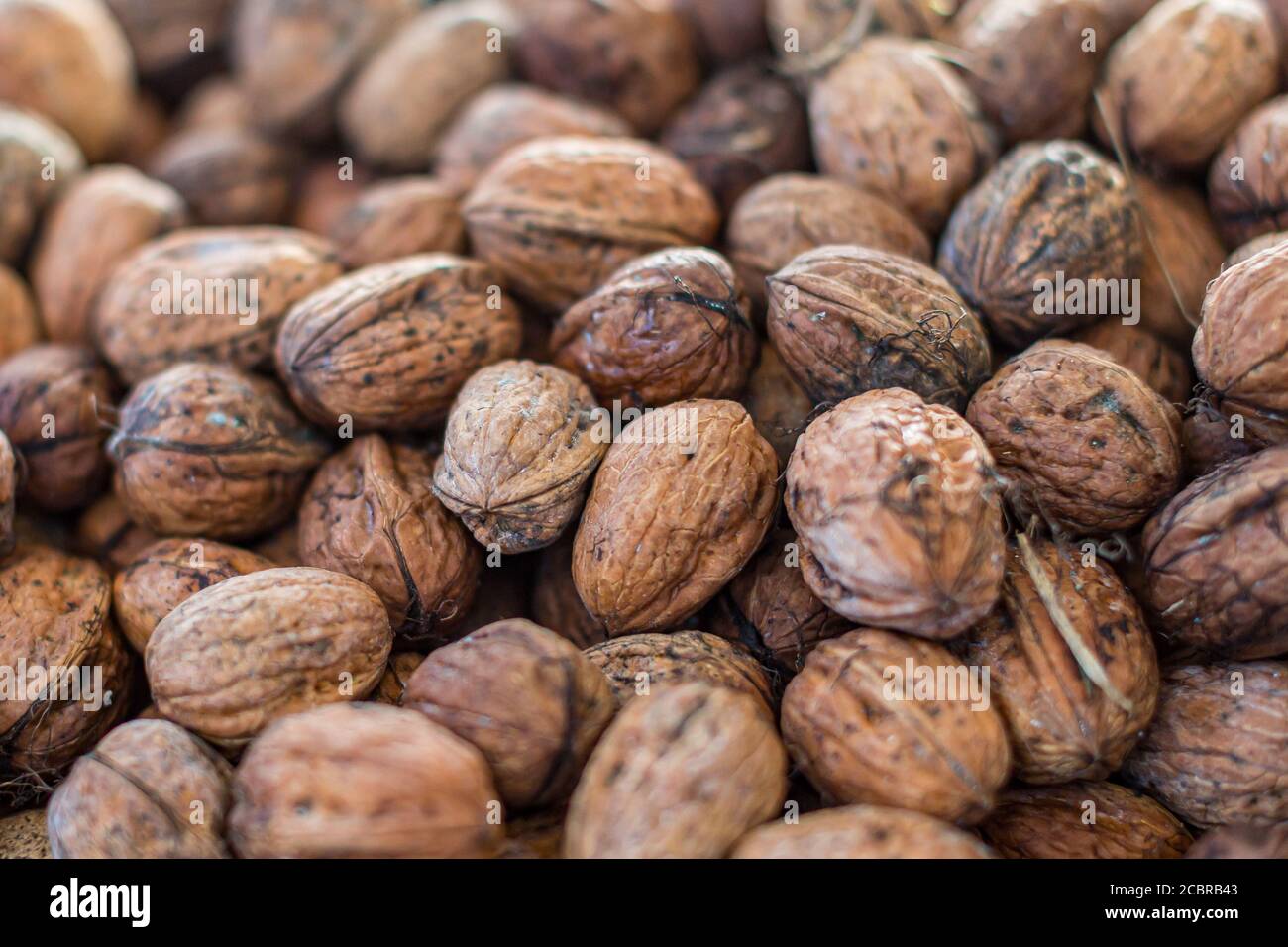 Walnuts in their shells for sale on a market stall Stock Photo - Alamy