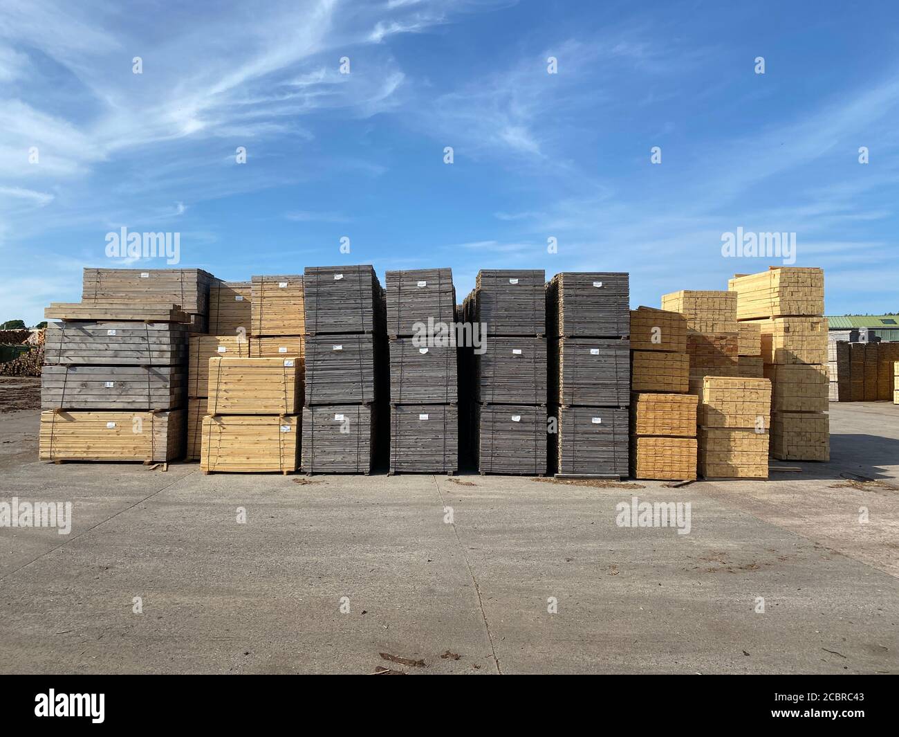 Stacked wooden pallets at wood sawmill and machinery Stock Photo - Alamy