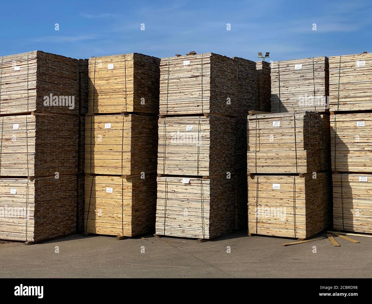 Stacked wooden pallets at wood sawmill and machinery Stock Photo - Alamy