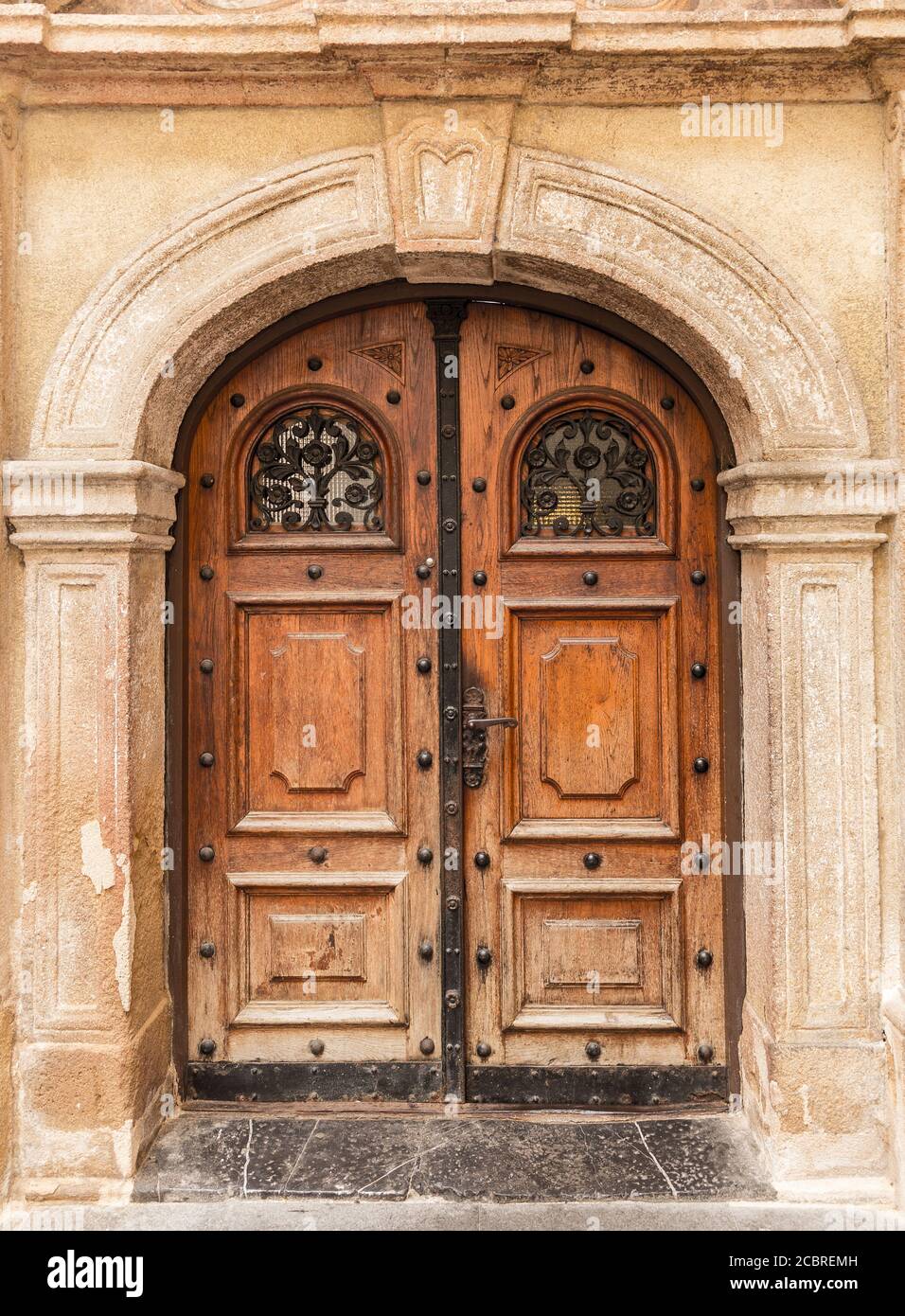 Old vintage building entrance door made of wood with metal enhancements ...