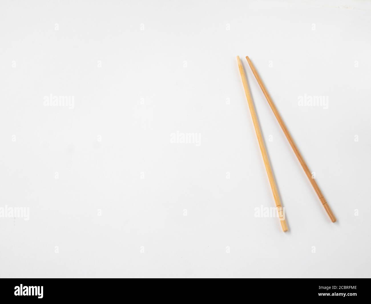 Chopsticks on white background Stock Photo - Alamy