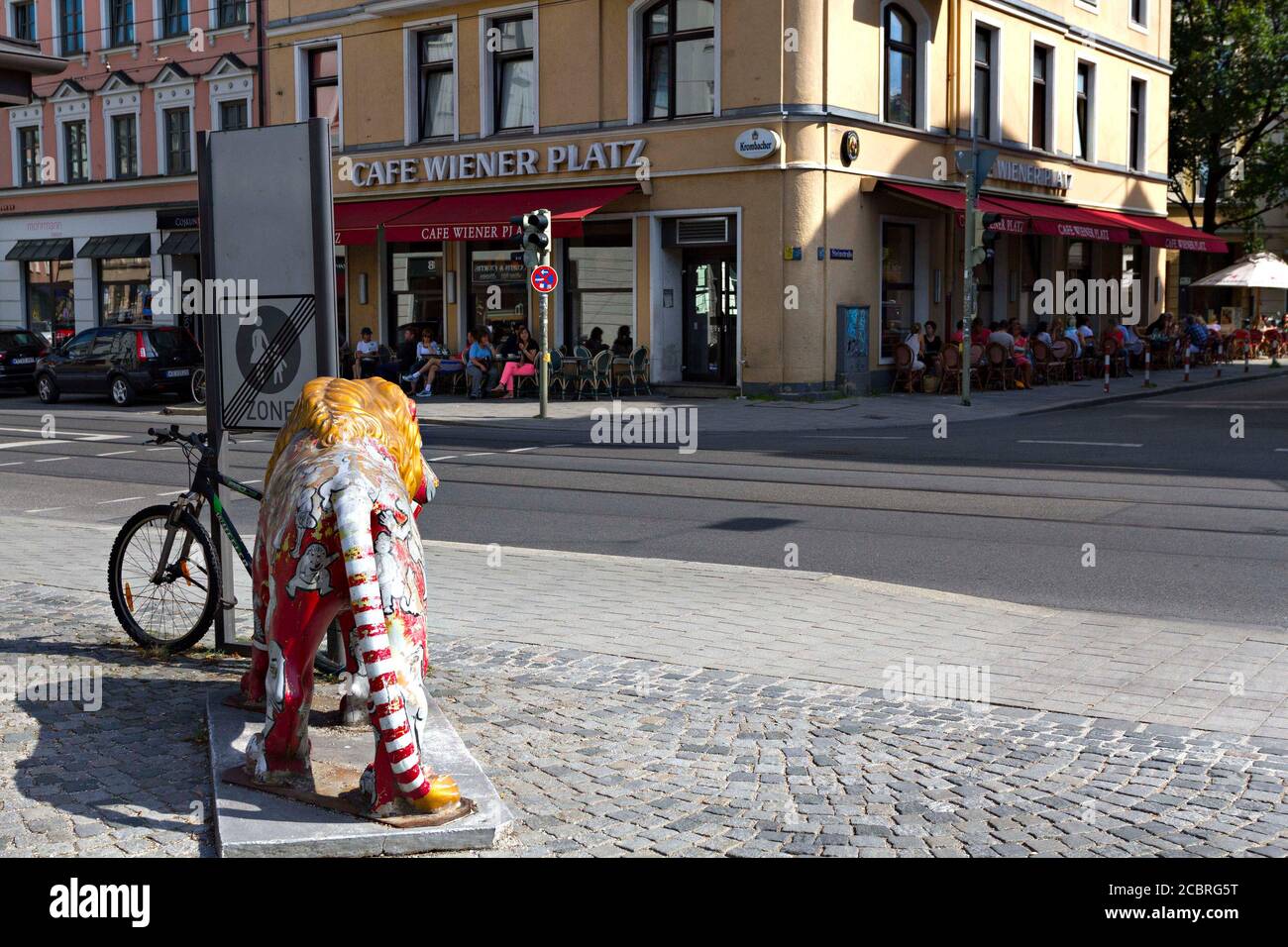 Cafe Wiener Platz with lion figure in foreground, Haidhausen, Munich ...