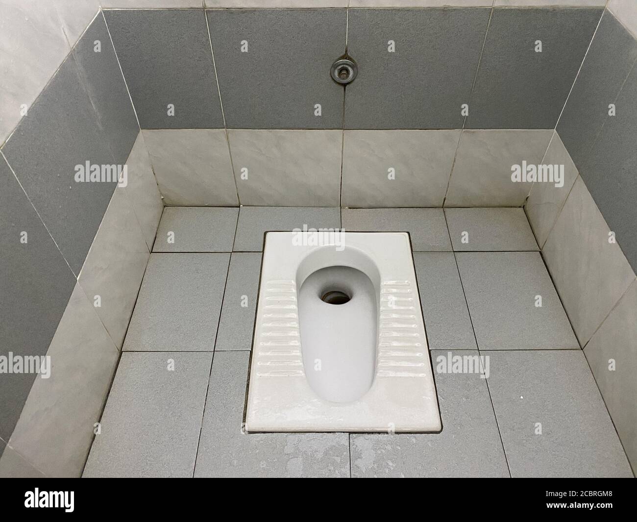View of a typical squat Asian toilet in Malaysia Stock Photo - Alamy