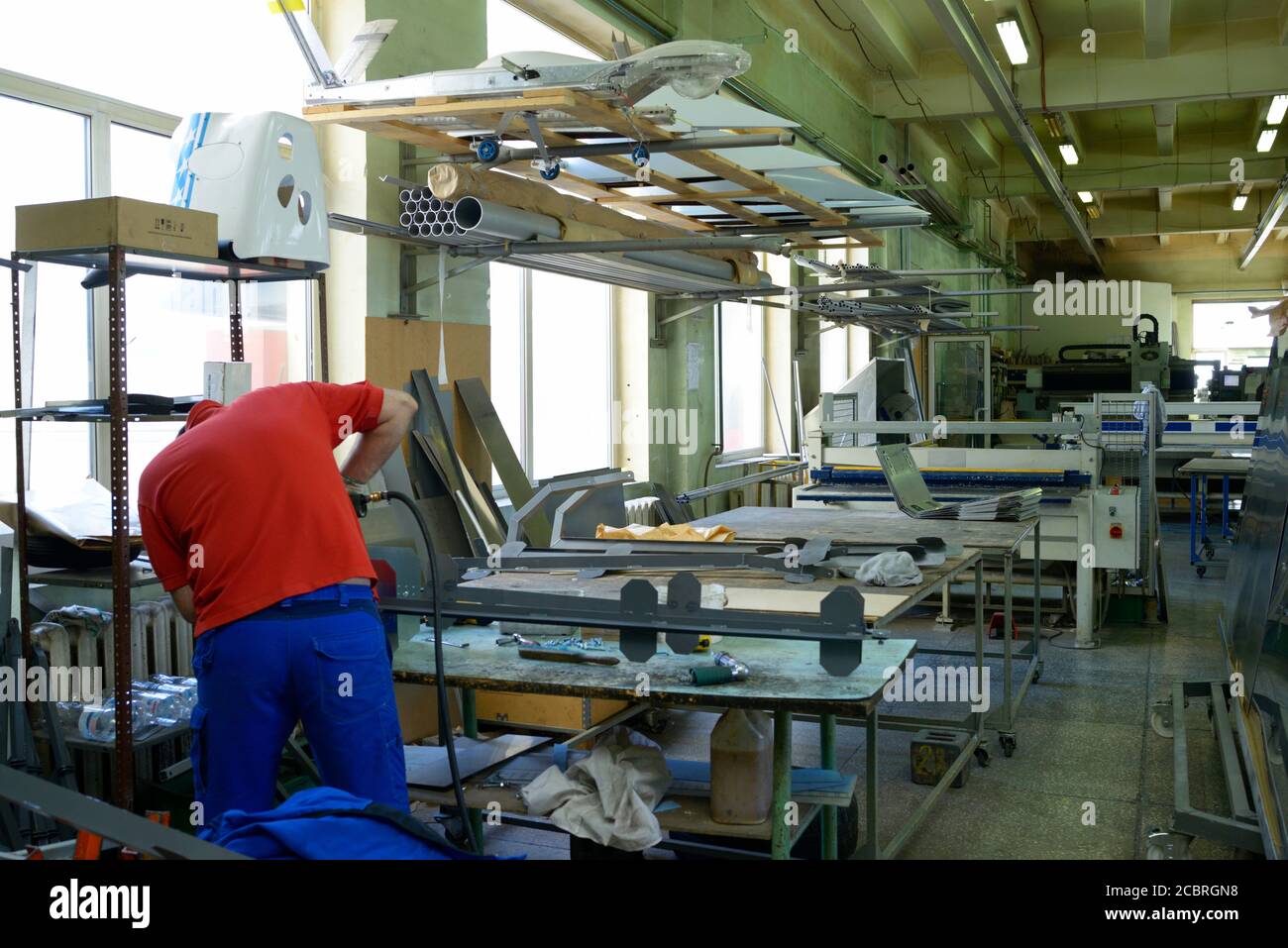 Plane assembly hall. Worker assembling fuselage of a light passenger ...