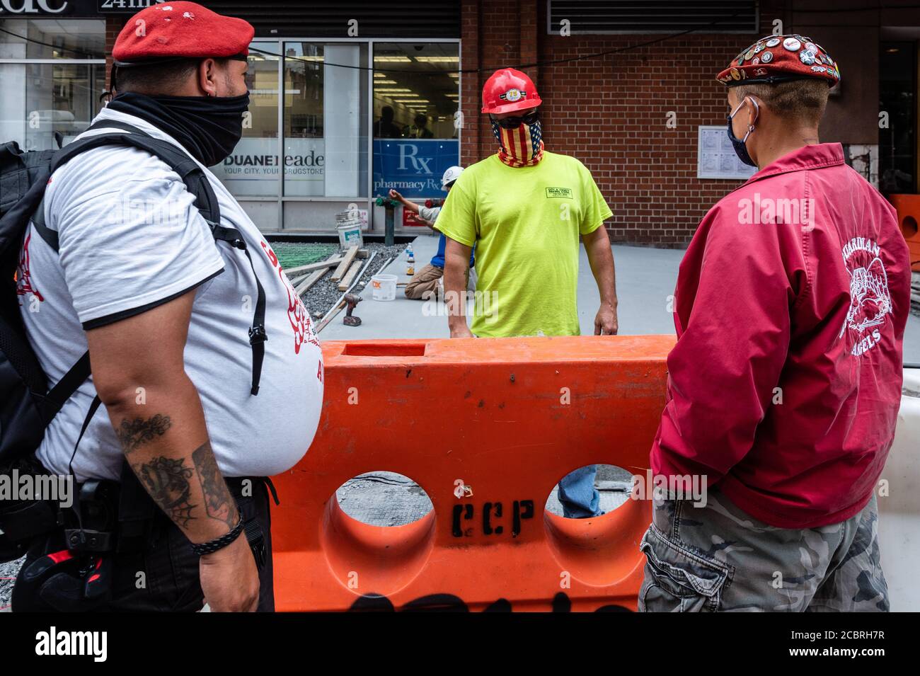 Member of the Guardian Angels talk to a construction worker on the ...