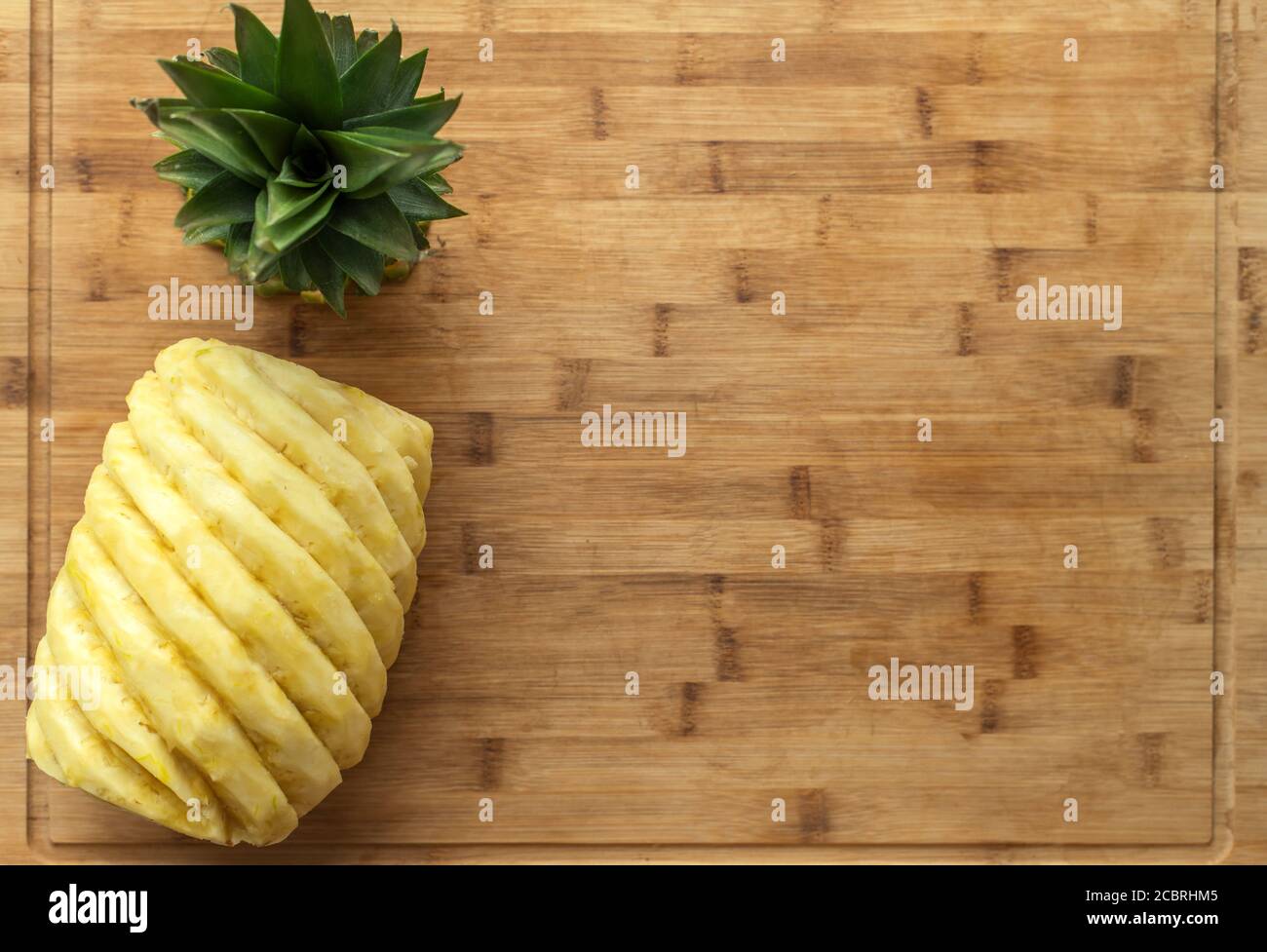 Ripe, juicy, yellow perfectly peeled pineapple, on a wooden background ...