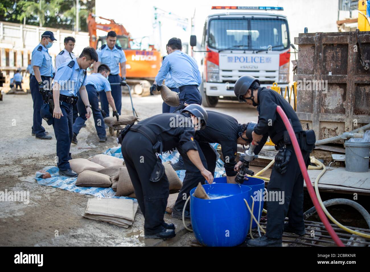 Hong Kong. 15th Aug, 2020. Police officers work at a construction site ...