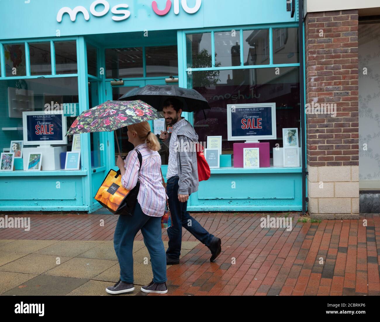 People walking out of shop raining hi-res stock photography and images ...