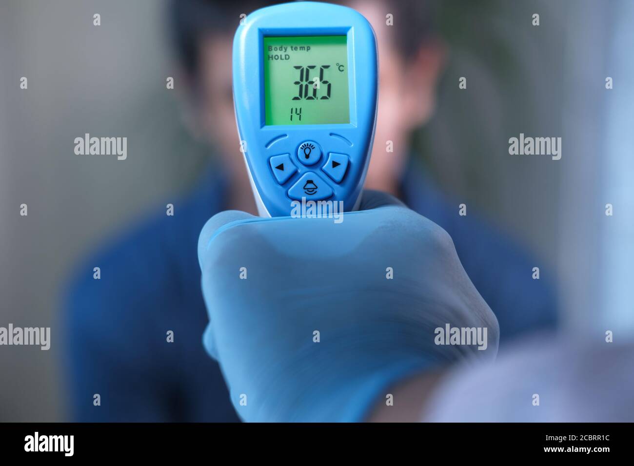Hand holding inferred thermometer check temperature Stock Photo - Alamy