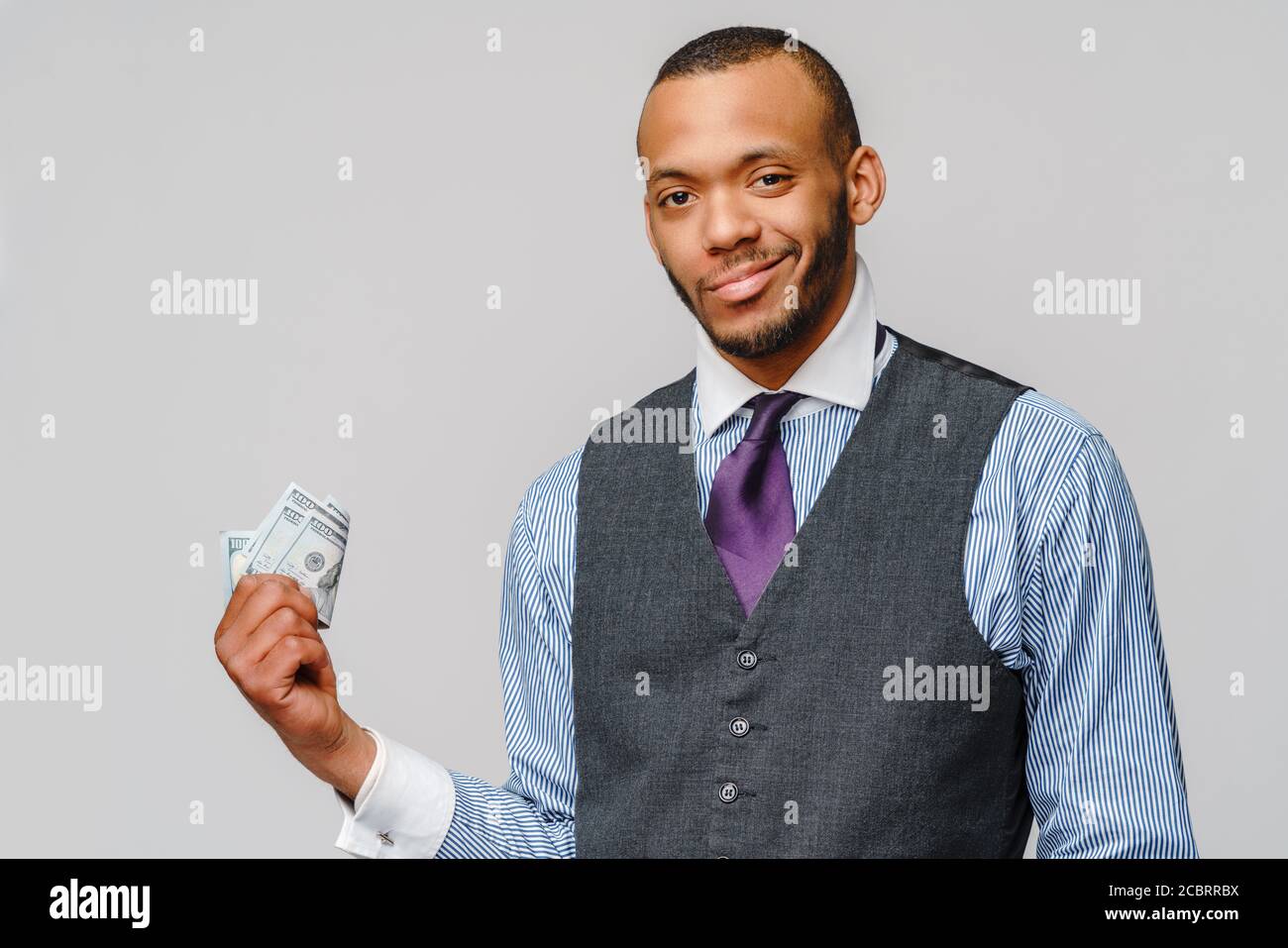 Portrait of excited young african american man holding cash money over ...